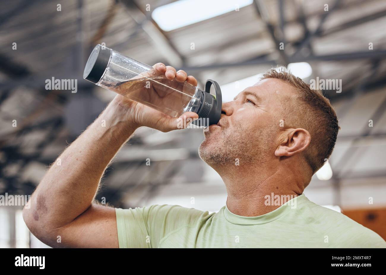 Man, fitness and drinking water bottle for detox after workout ...