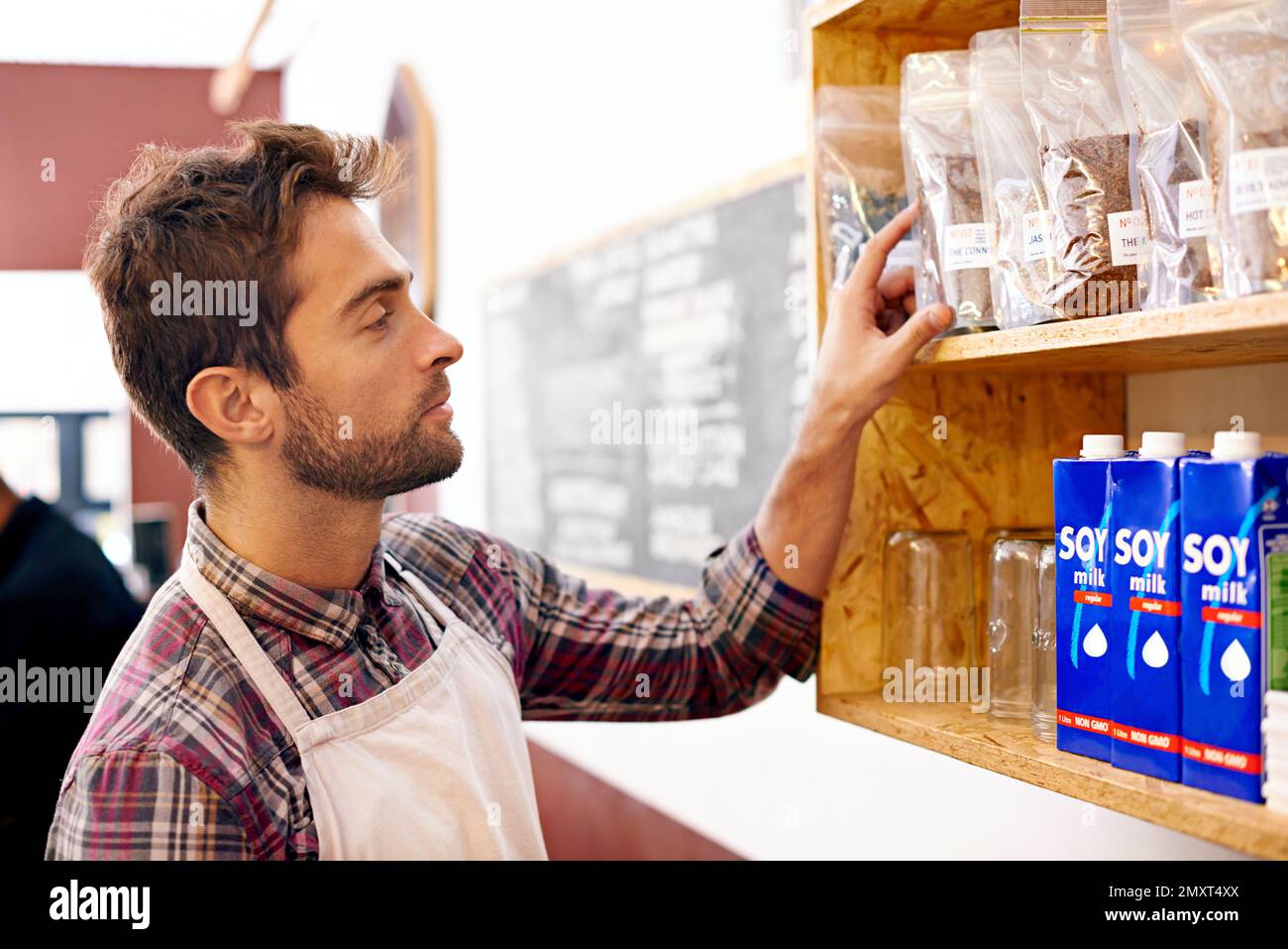 Selecting only the best. a barista counting his merchandise Stock Photo ...