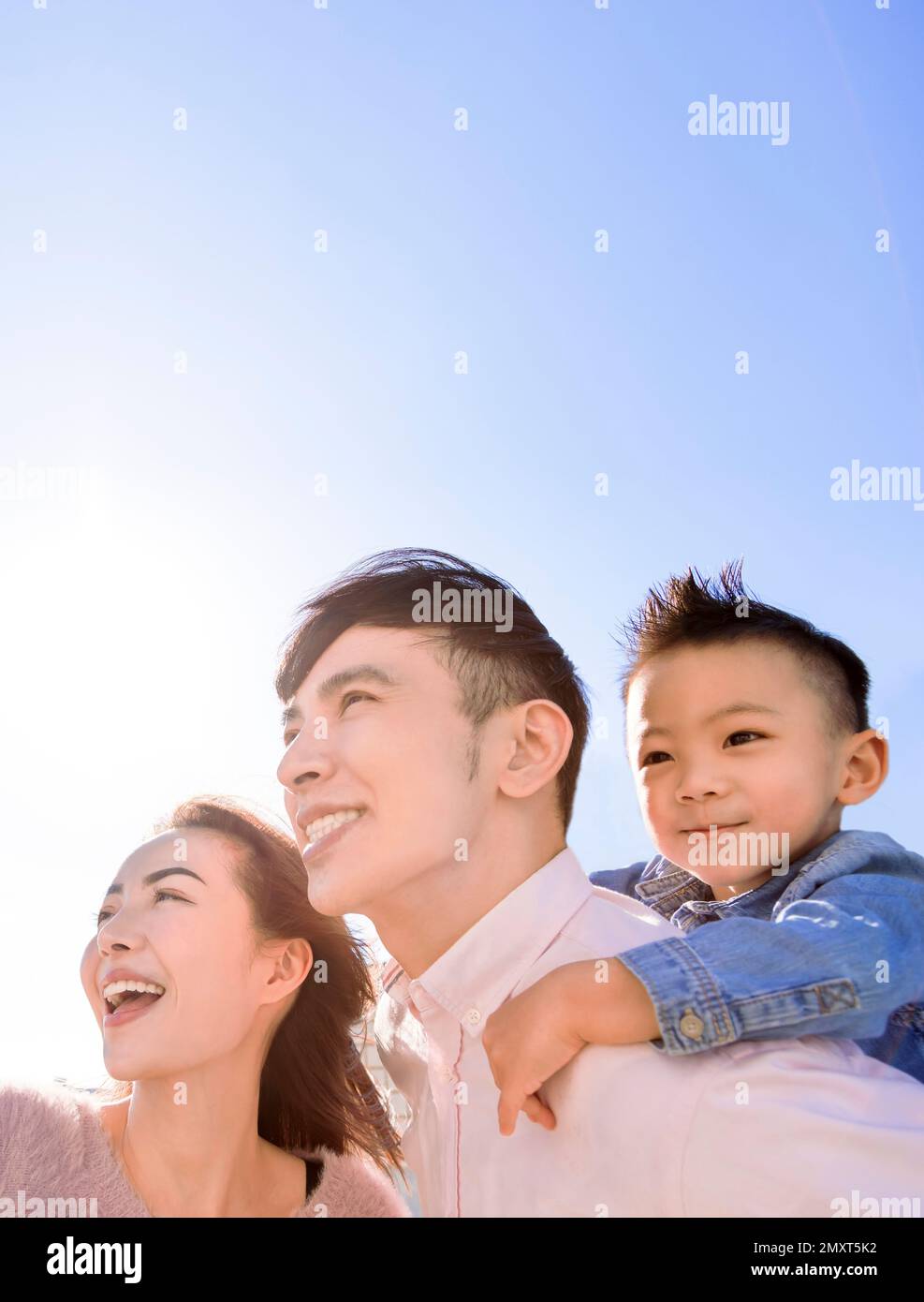 Happy family standing and looking forward Stock Photo - Alamy