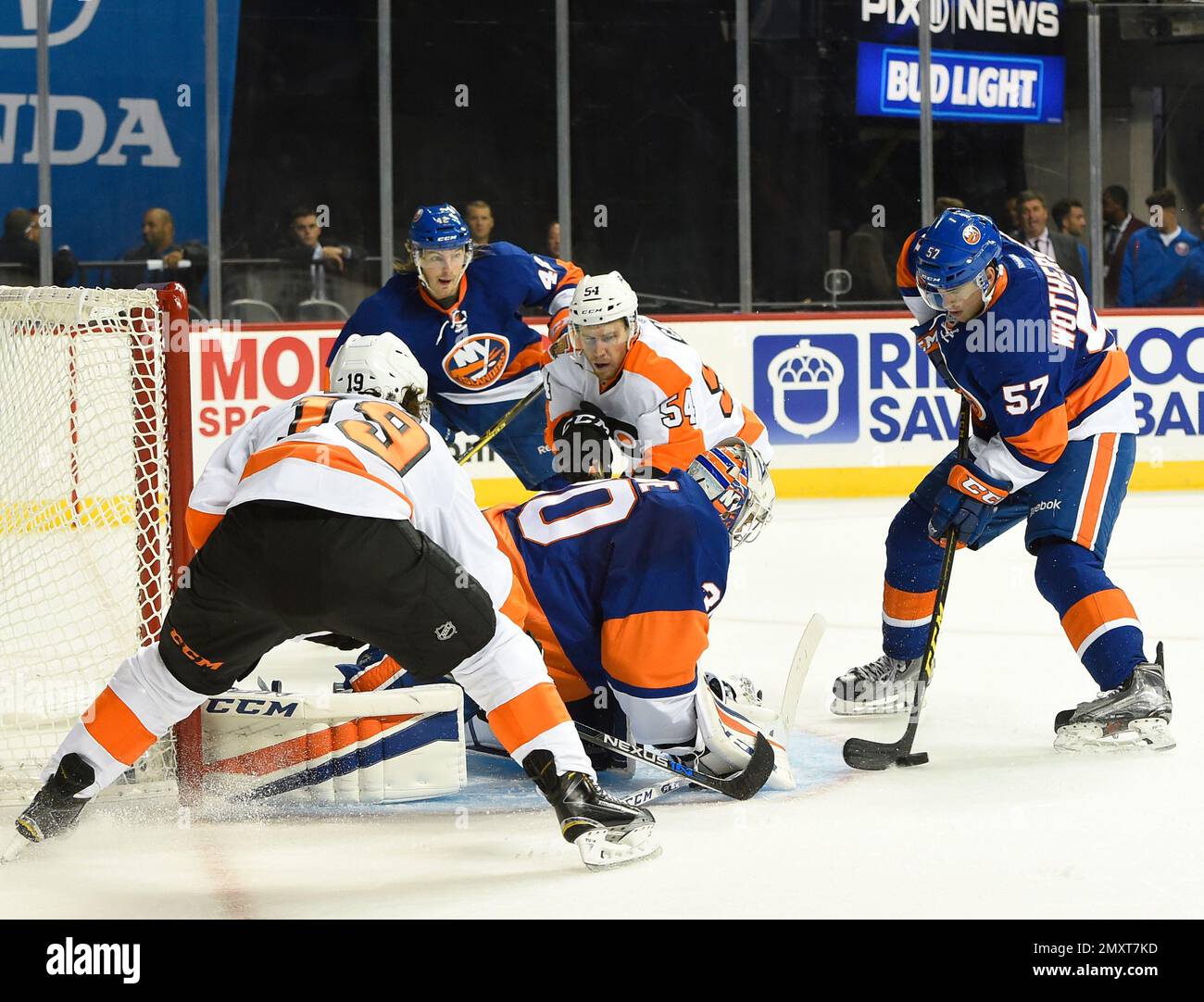 New York Islanders goalie Jean-Francois Berube (30), defenseman Parker ...