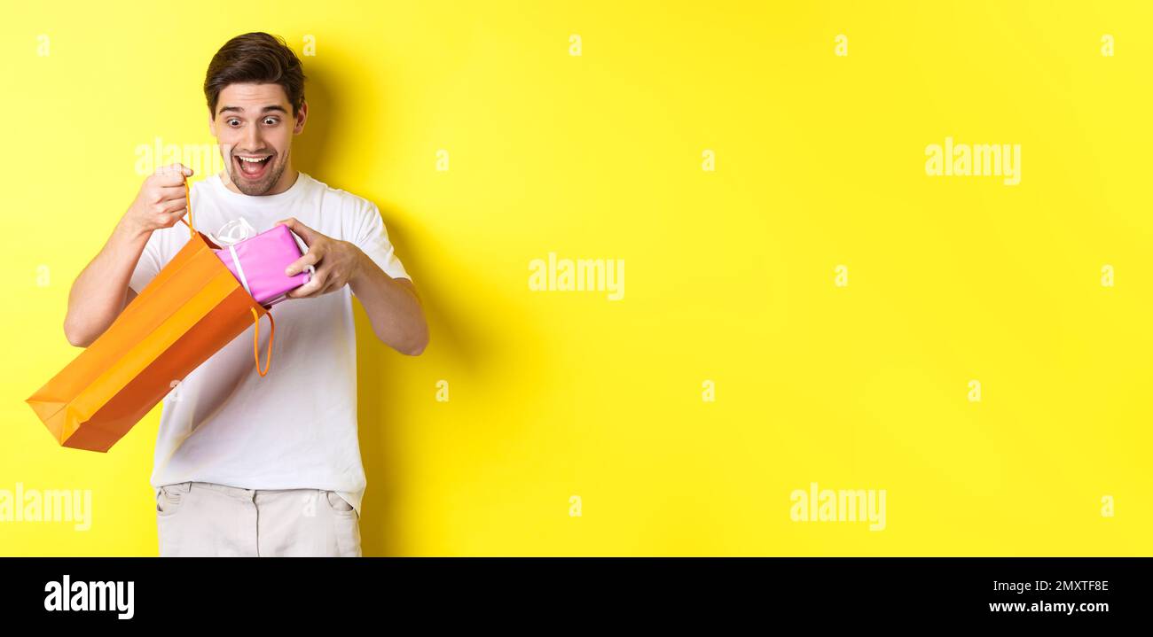 Concept of holidays and celebration. Young man looking surprised as ...