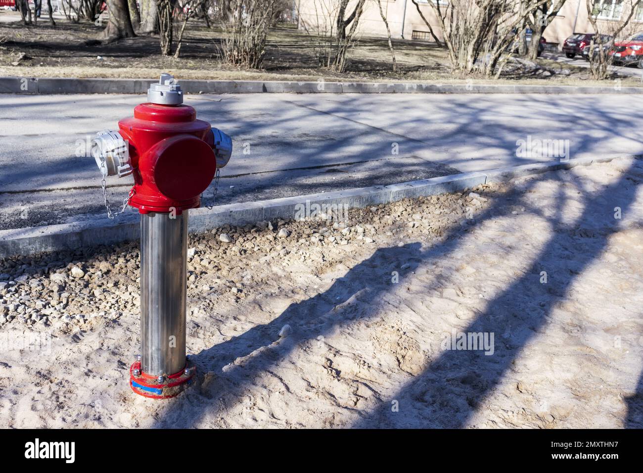 Red fire water tank on green grass on road background Stock Photo - Alamy