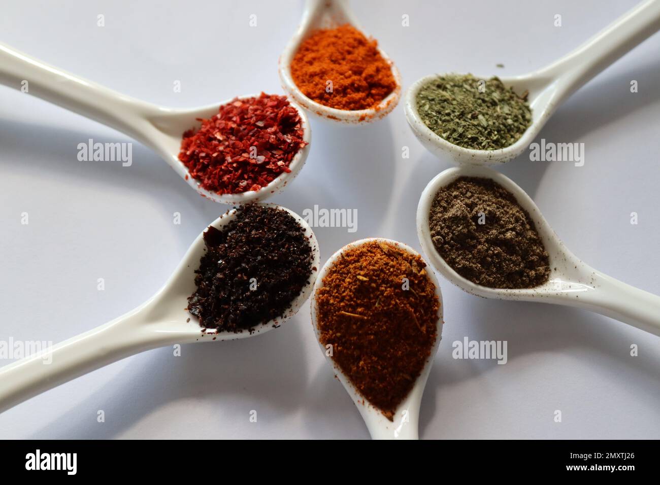 Various spices isolated on white background. Ground black pepper, chili ...