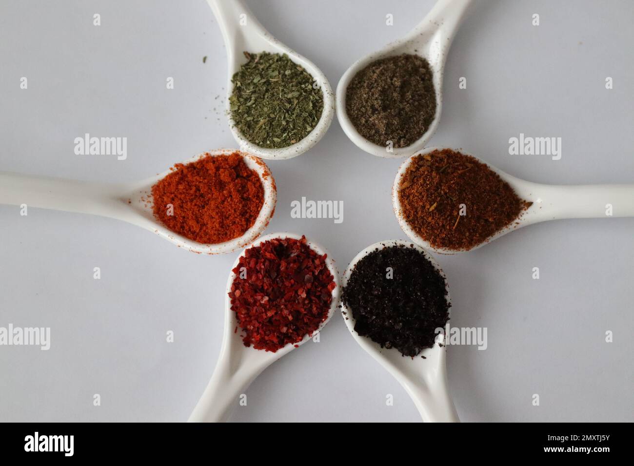 Various spices isolated on white background. Ground black pepper, chili ...