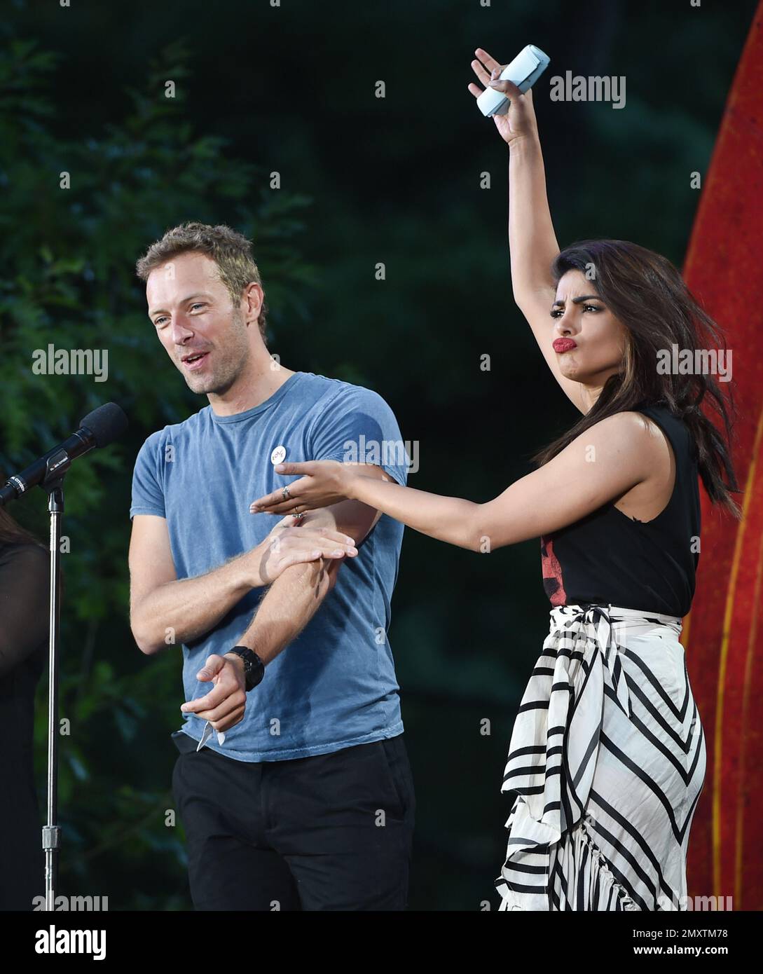 Actress Priyanka Chopra, left, and musician Chris Martin speak at the ...