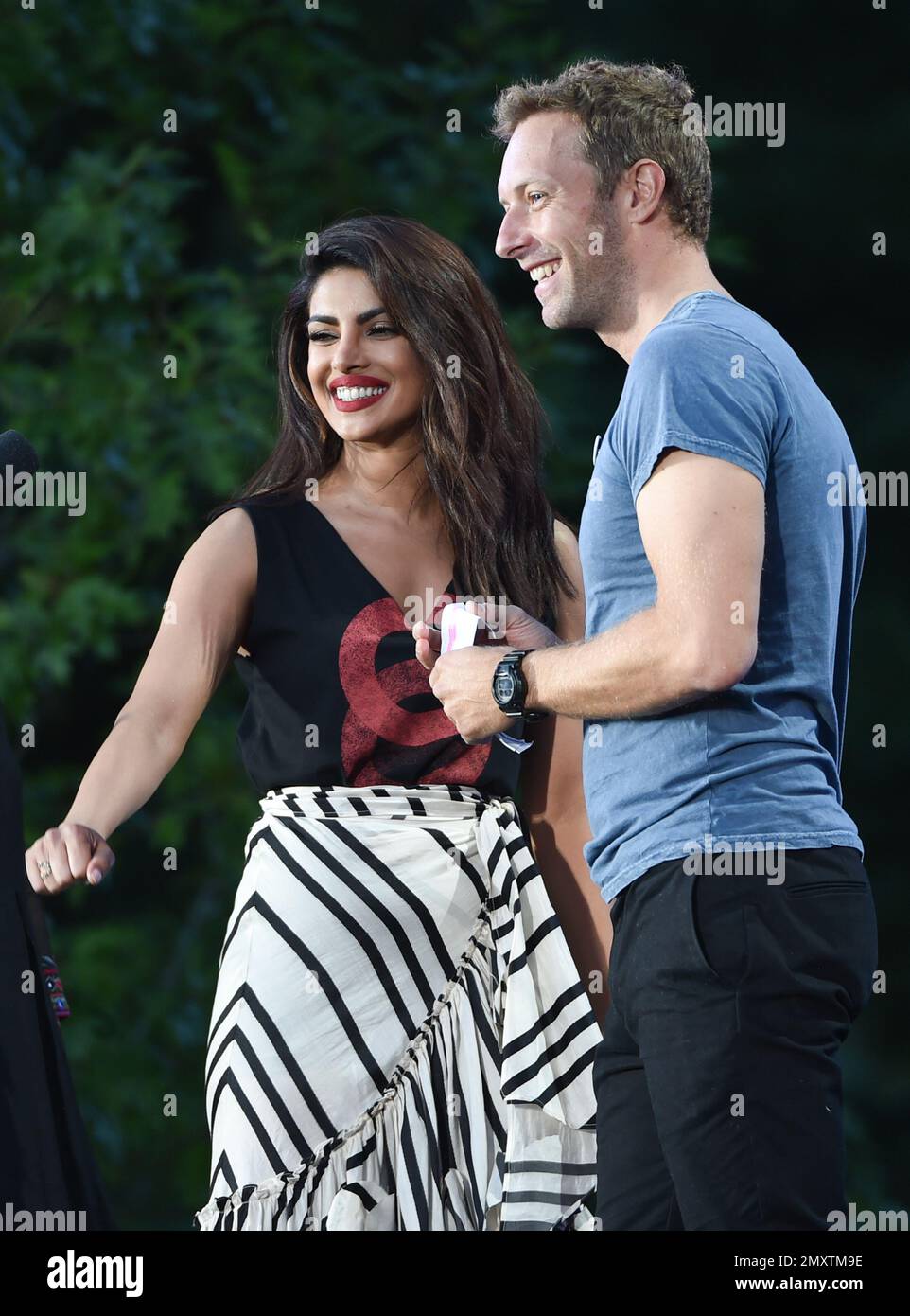 Actress Priyanka Chopra, left, and musician Chris Martin speak at the ...