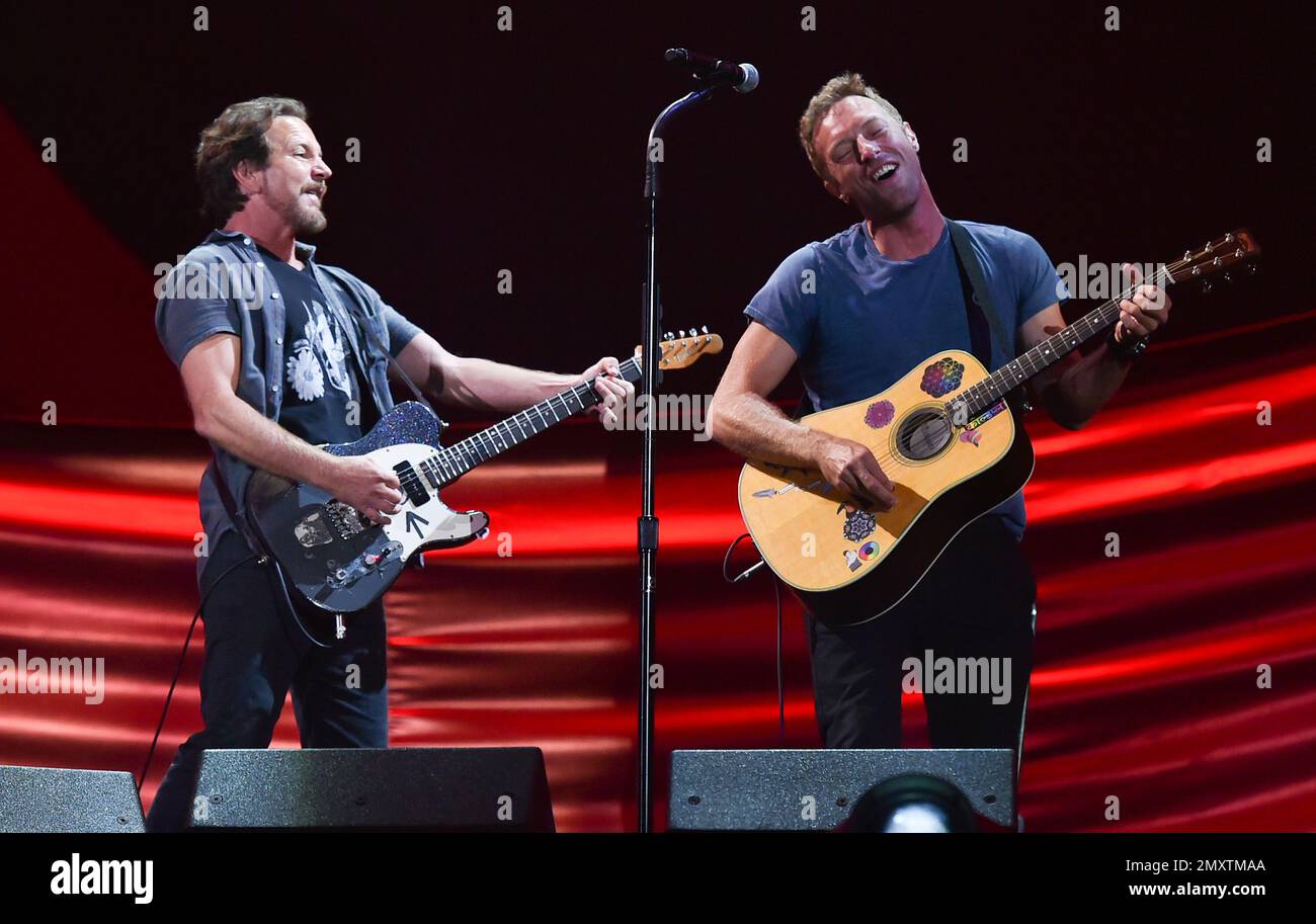 Musicians Eddie Vedder, left, and Chris Martin perform together at the ...