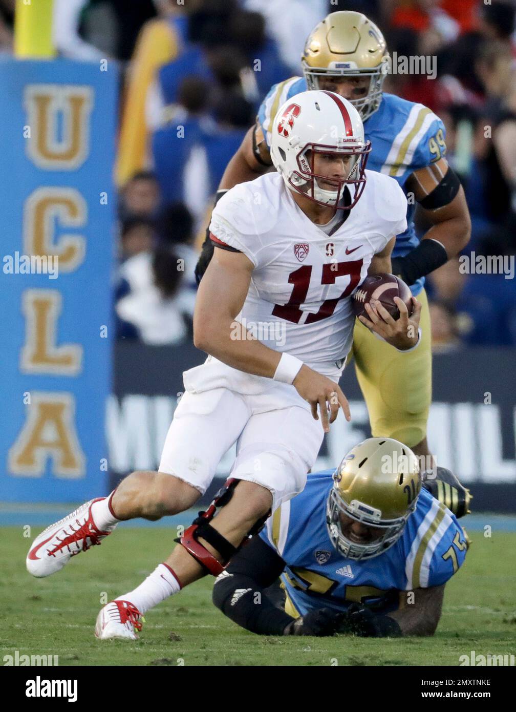 Stanford quarterback Ryan Burns runs past UCLA defensive lineman Boss ...