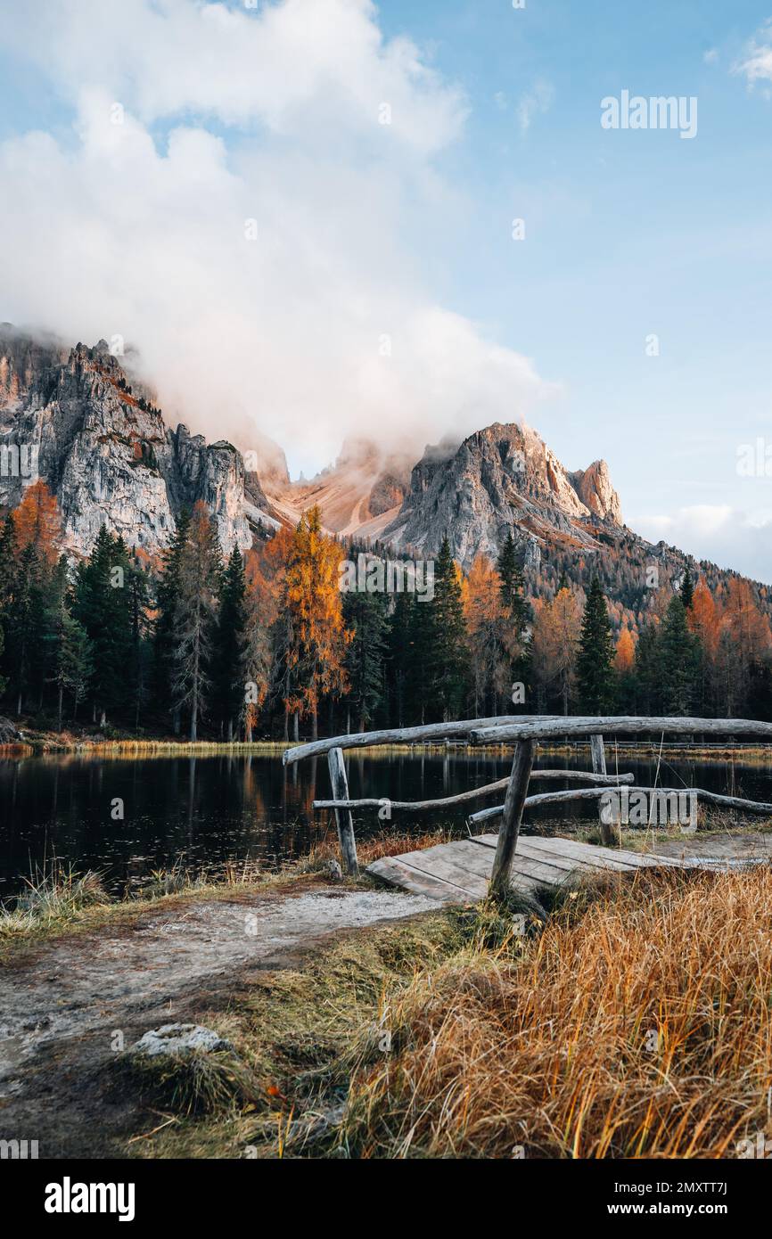 Autumn colours of Lake Lago d'Antorno and bridge in Dolomites Italy ...