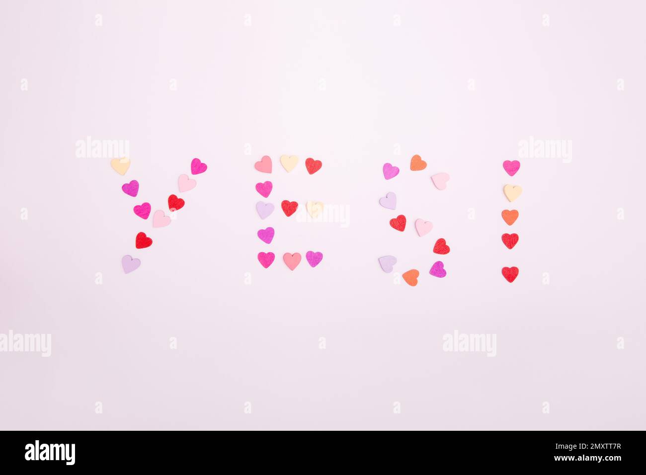 The word yes and an exclamation mark made from hearts on a gray ...