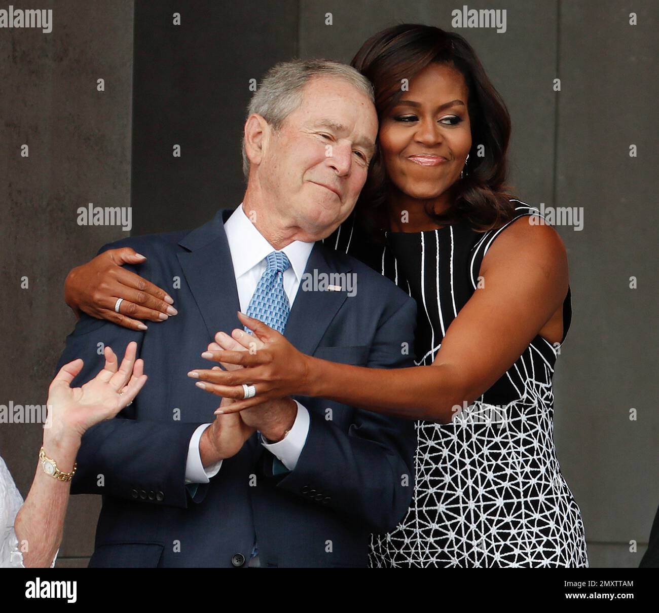 First lady Michelle Obama hugs former President George W. Bush during ...