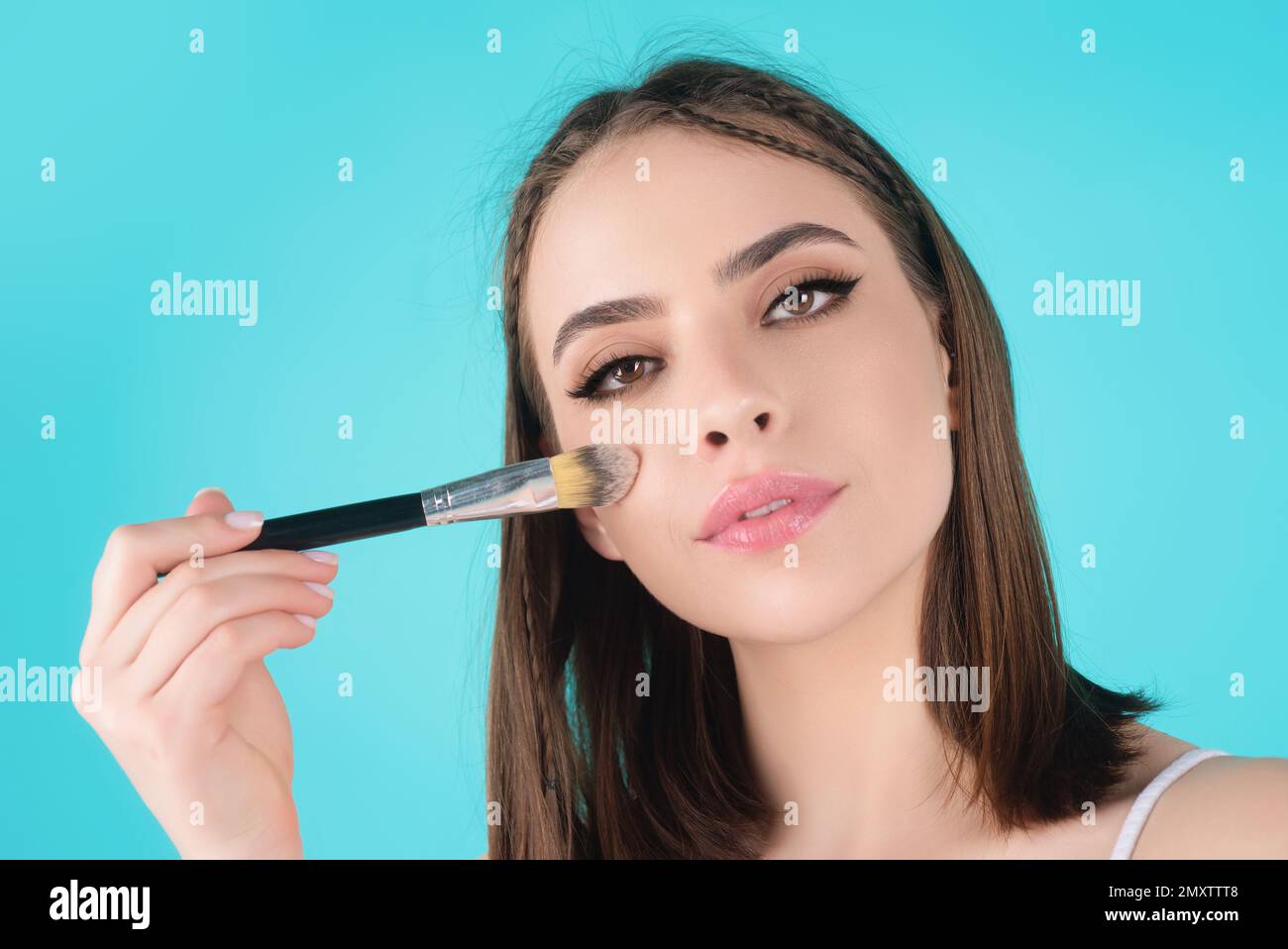 Girl hold blush blusher apply powder visage isolated over studio ...