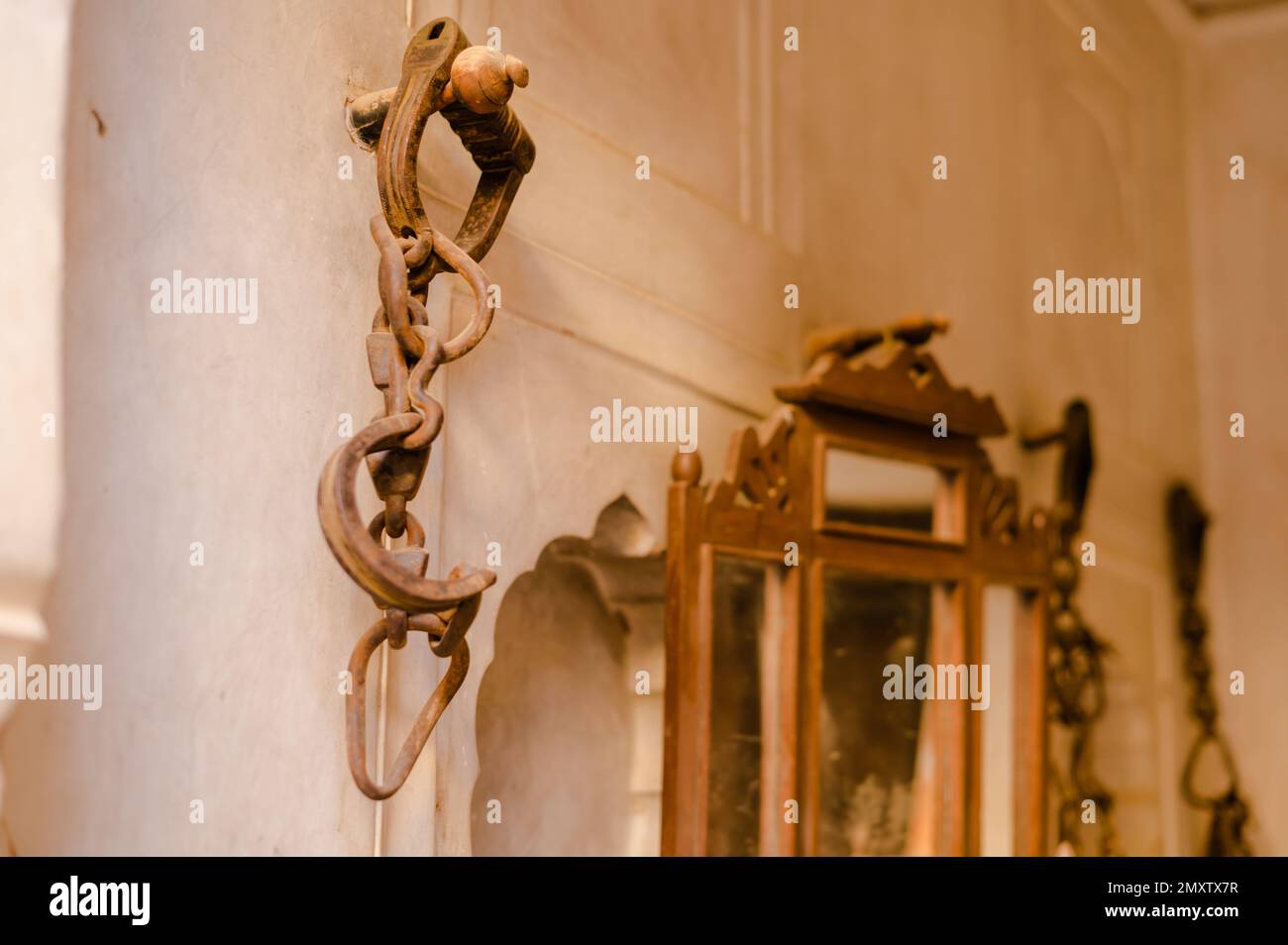 A closeup of shackles for prisoners hang on the wall Stock Photo - Alamy