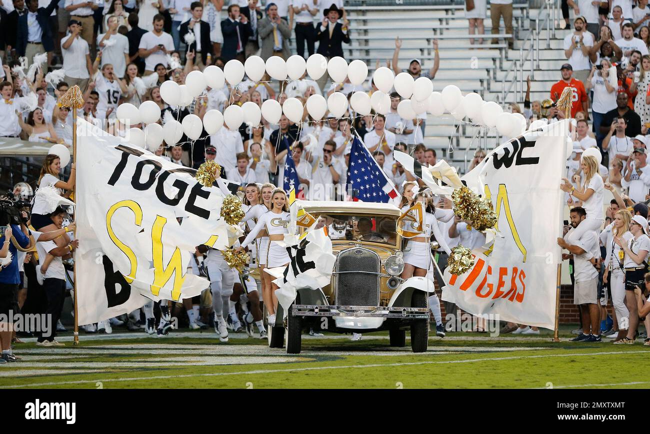The Rambling Wreck leads the Georgia Tech Yellow Jackets onto the field ...