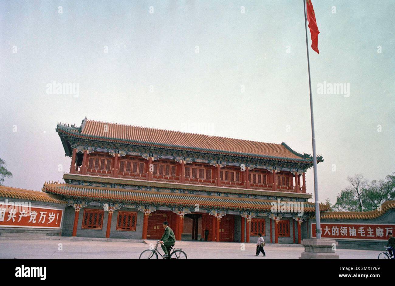 A Cyclist rides his bike past the ornate entrance to Beijing's ...