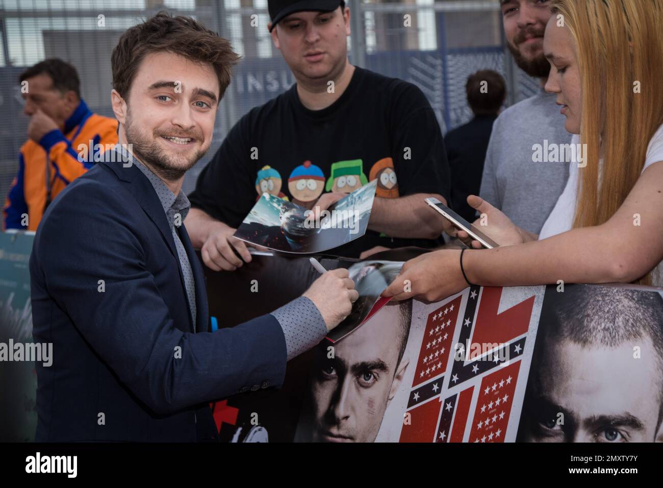 Daniel Radcliffe poses for pictures with fans upon arrival at the ...