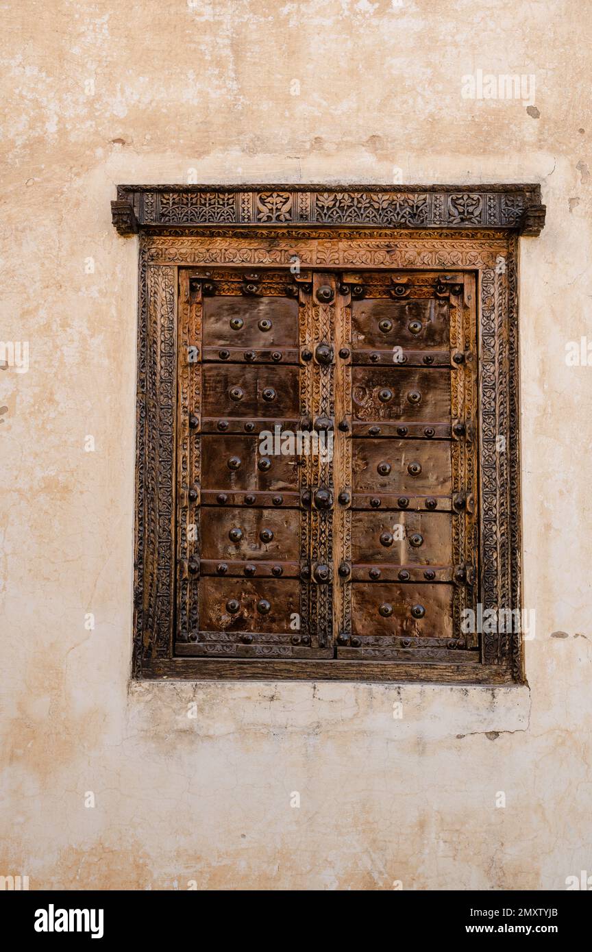 A vertical shot of an old traditional Indian gate on the wall of a ...