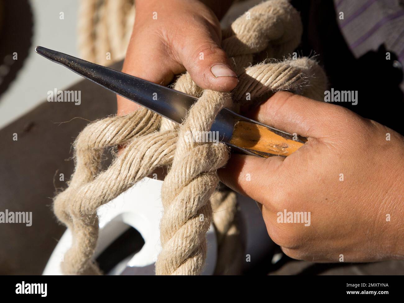 In this Sept. 15, 2016 photo, a rigger uses a Swedish fid to splice ...