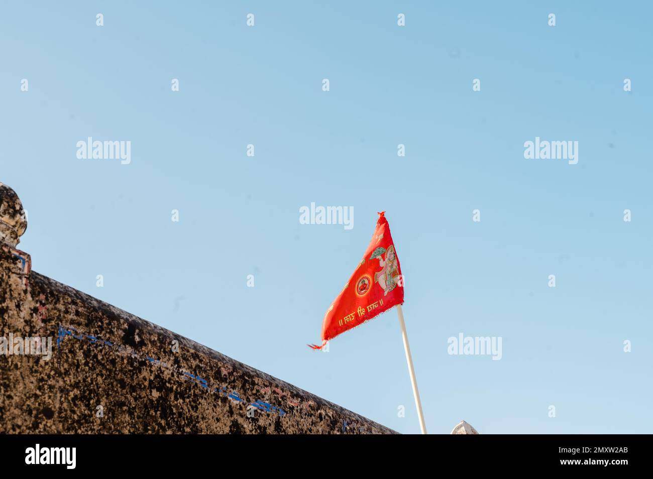 The Hanuman flag waving on the top of a building under the blue sky ...