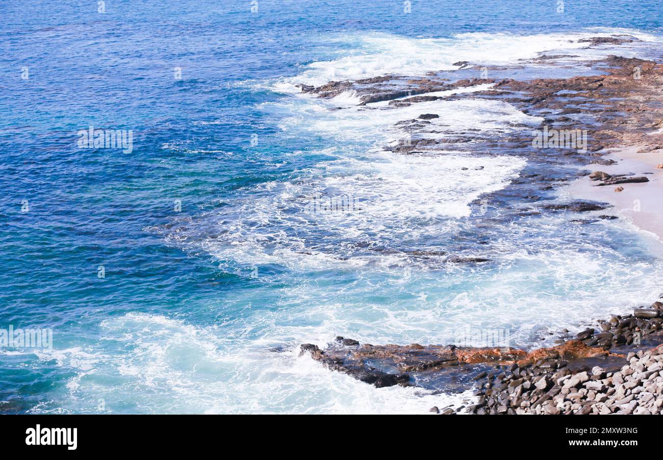 The rocky coast of the sea with clear blue water Stock Photo - Alamy
