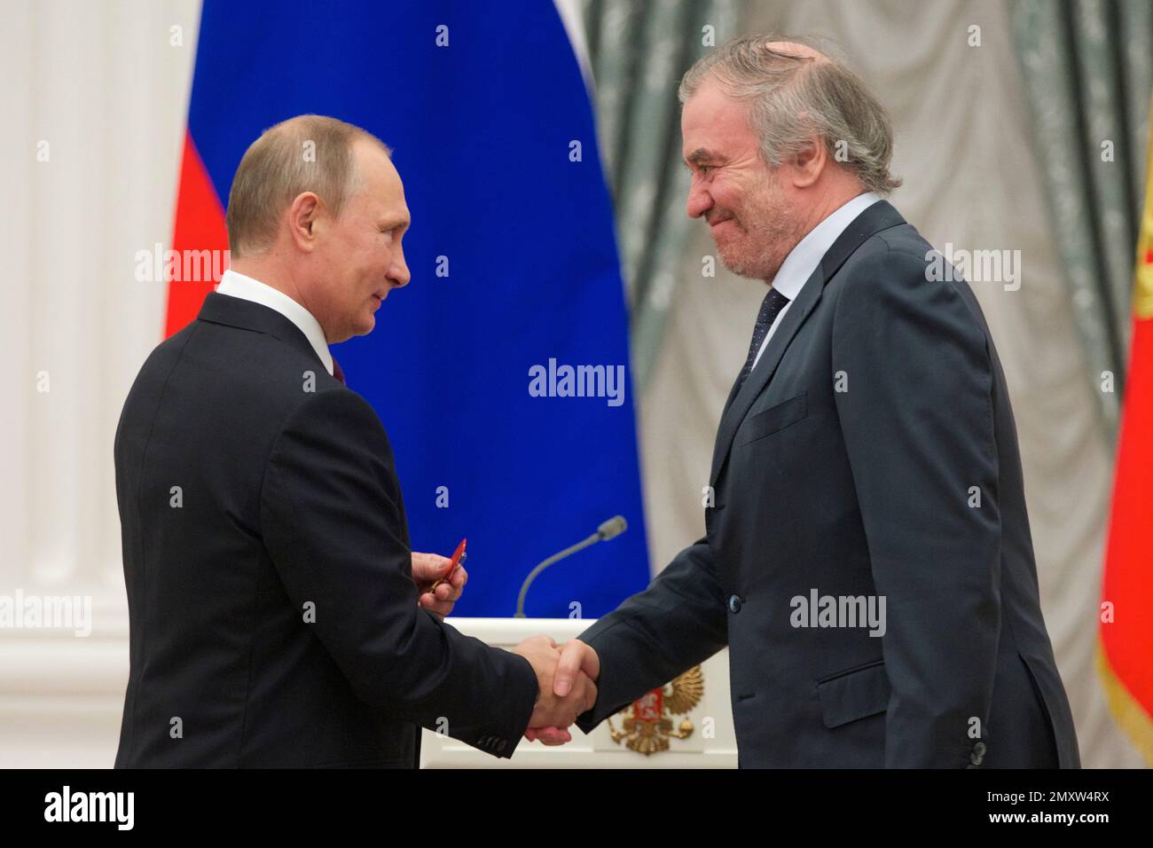 Russian President Vladimir Putin, left, presents a medal Mariinsky ...