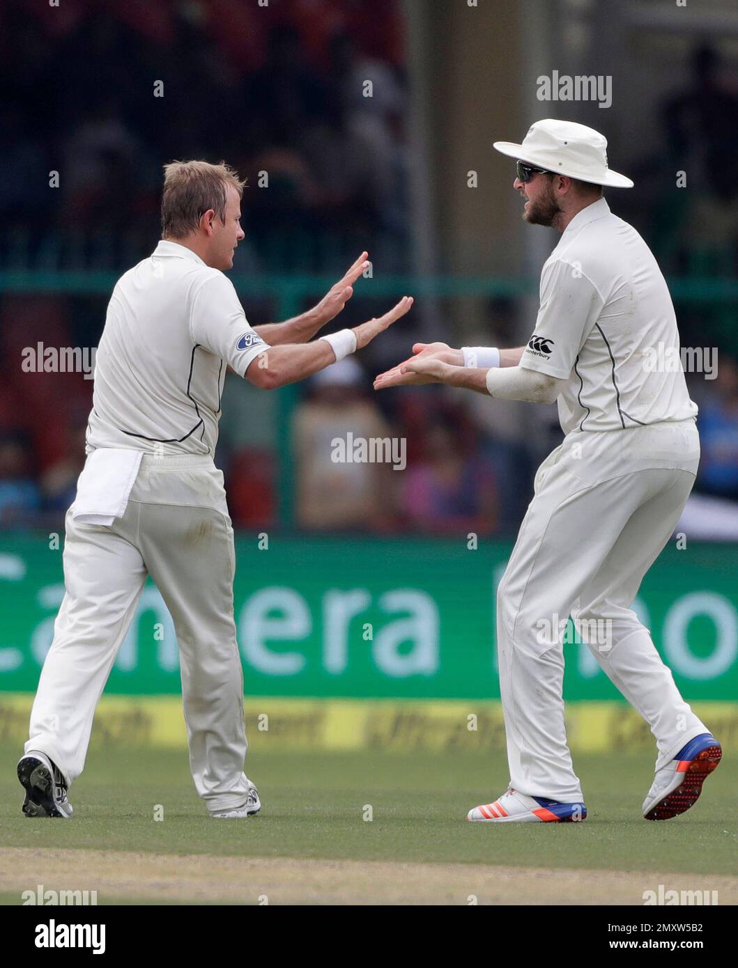 New Zealand's Tom Latham, left and Mark Craig celebrate the wicket of ...