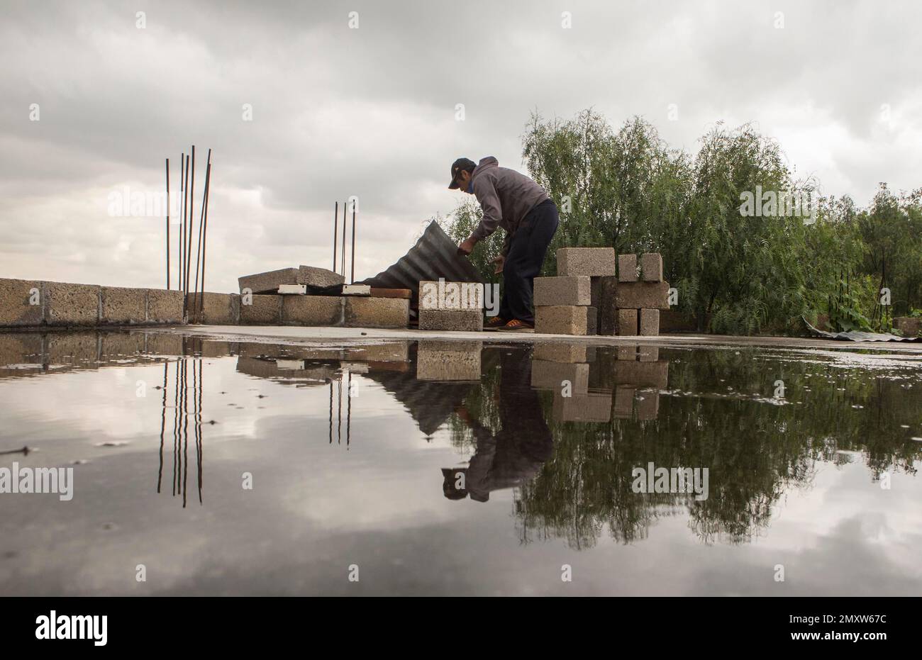 In this Sept. 3, 2016 photo, Edgar Serralde works on his rooftop on the ...
