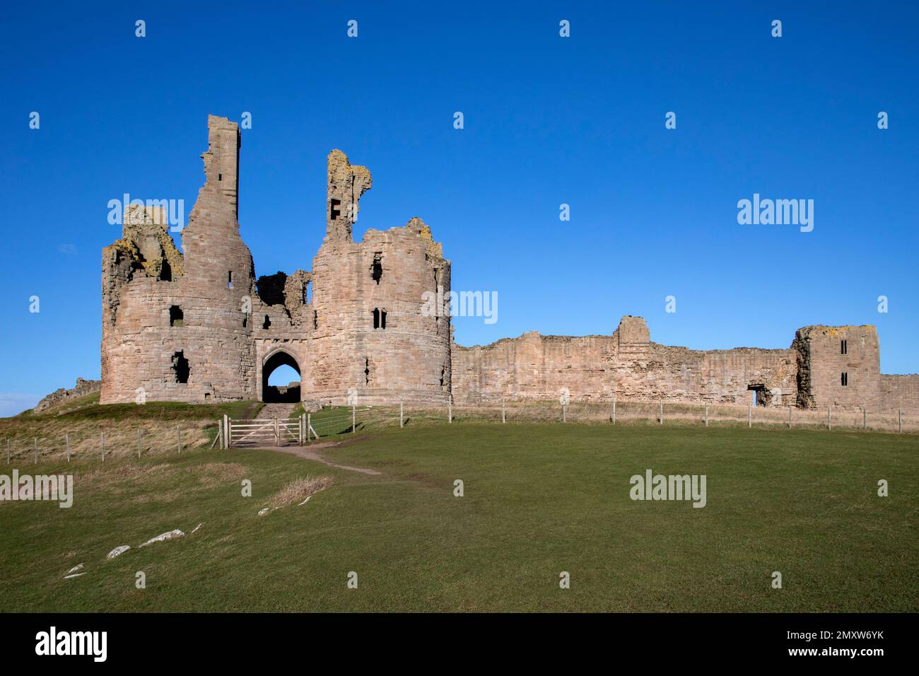 The 14th-century fortiress of Dunstanburgh Castle on the coast of ...
