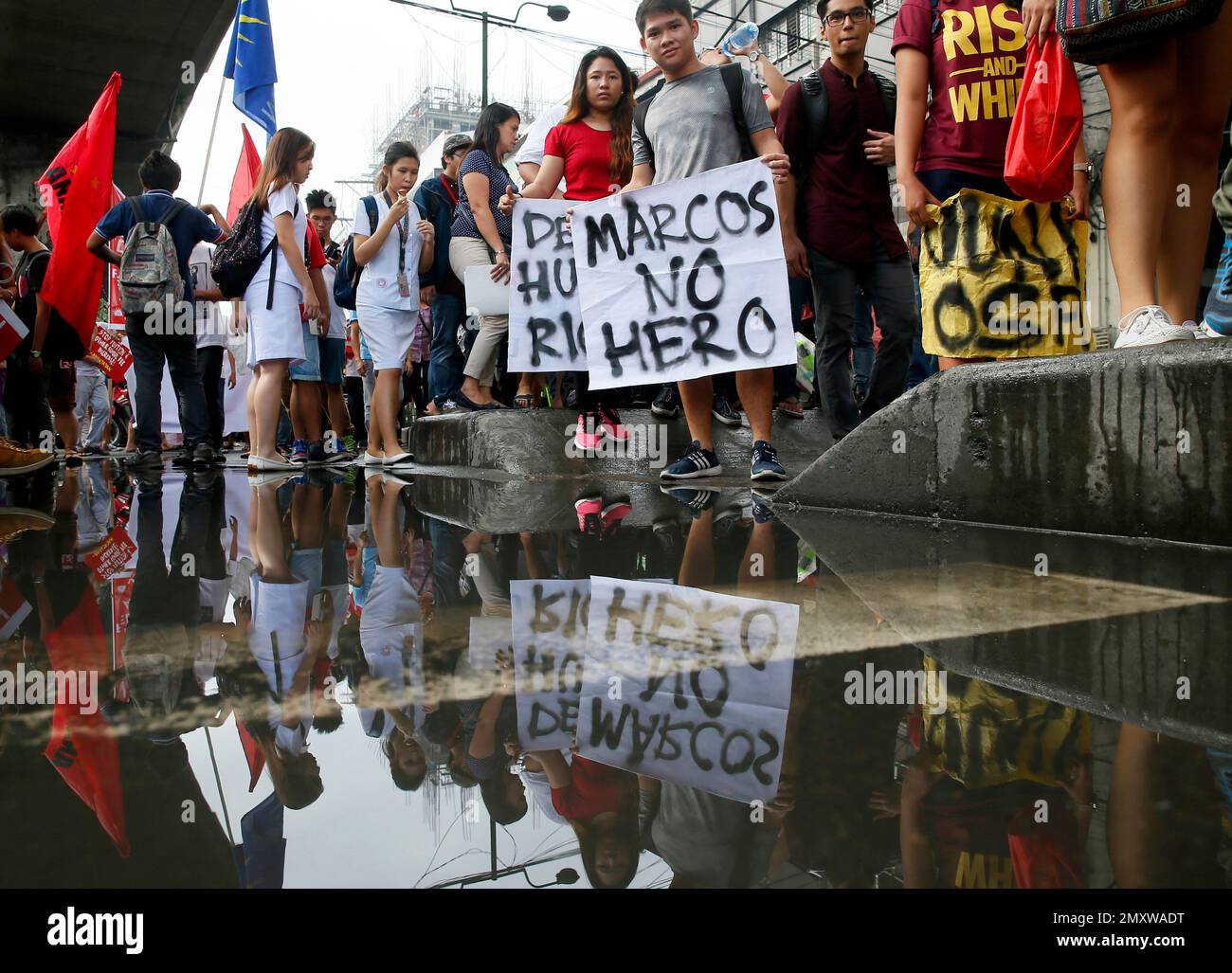 Protesters carry banners and placards as they march towards the ...