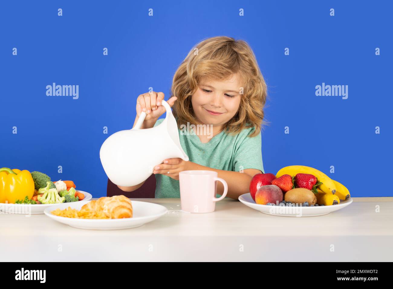 Healthy breakfast for kids. Kid with dairy milk. Cheerful kid keeping ...