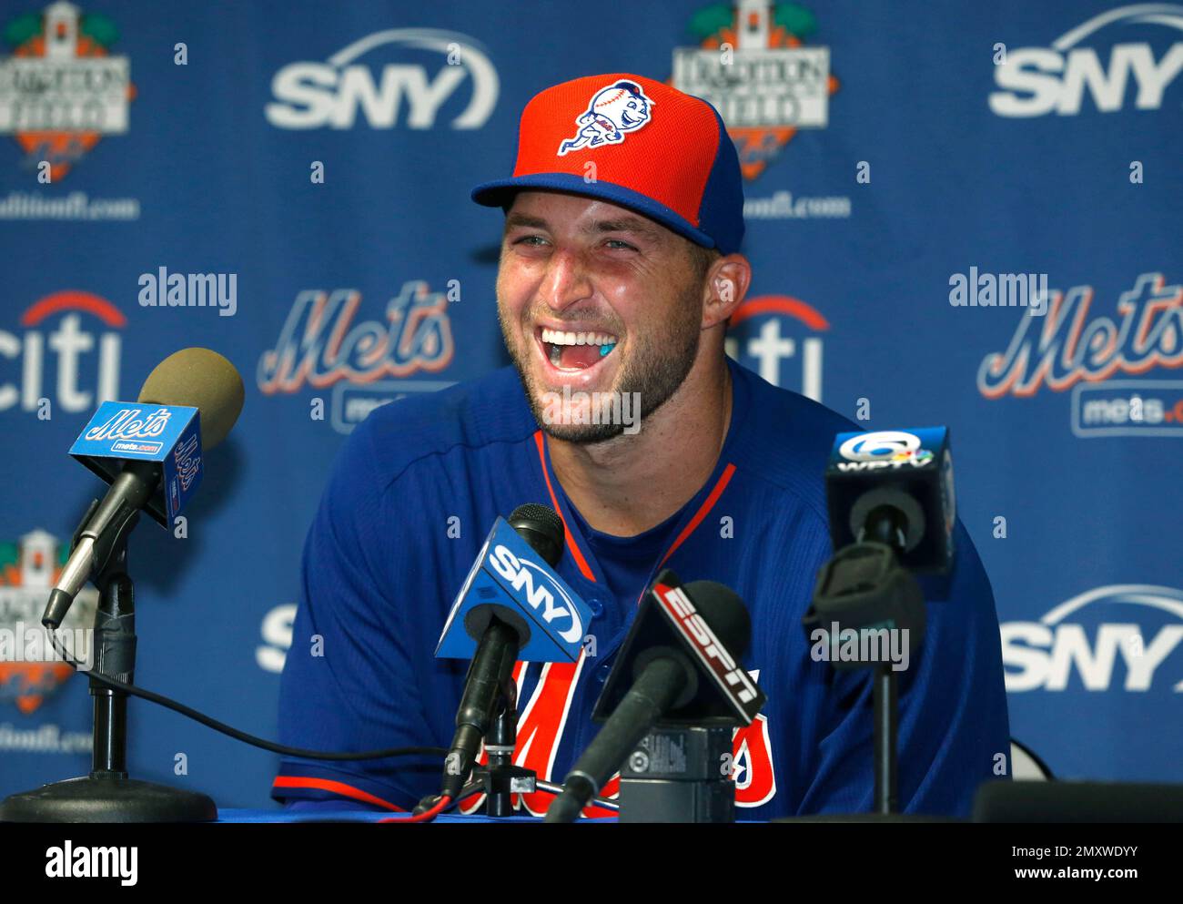 Tim Tebow laughs during a news conference, Tuesday, Sept. 20, 2016, in ...