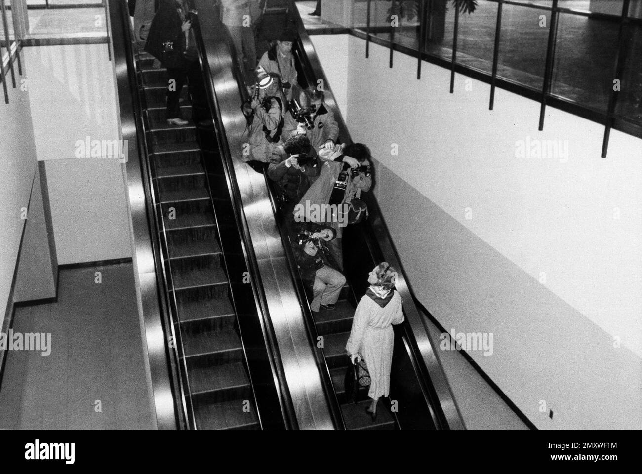 Jean Harris, bottom, is confronted by line of photographers on an ...