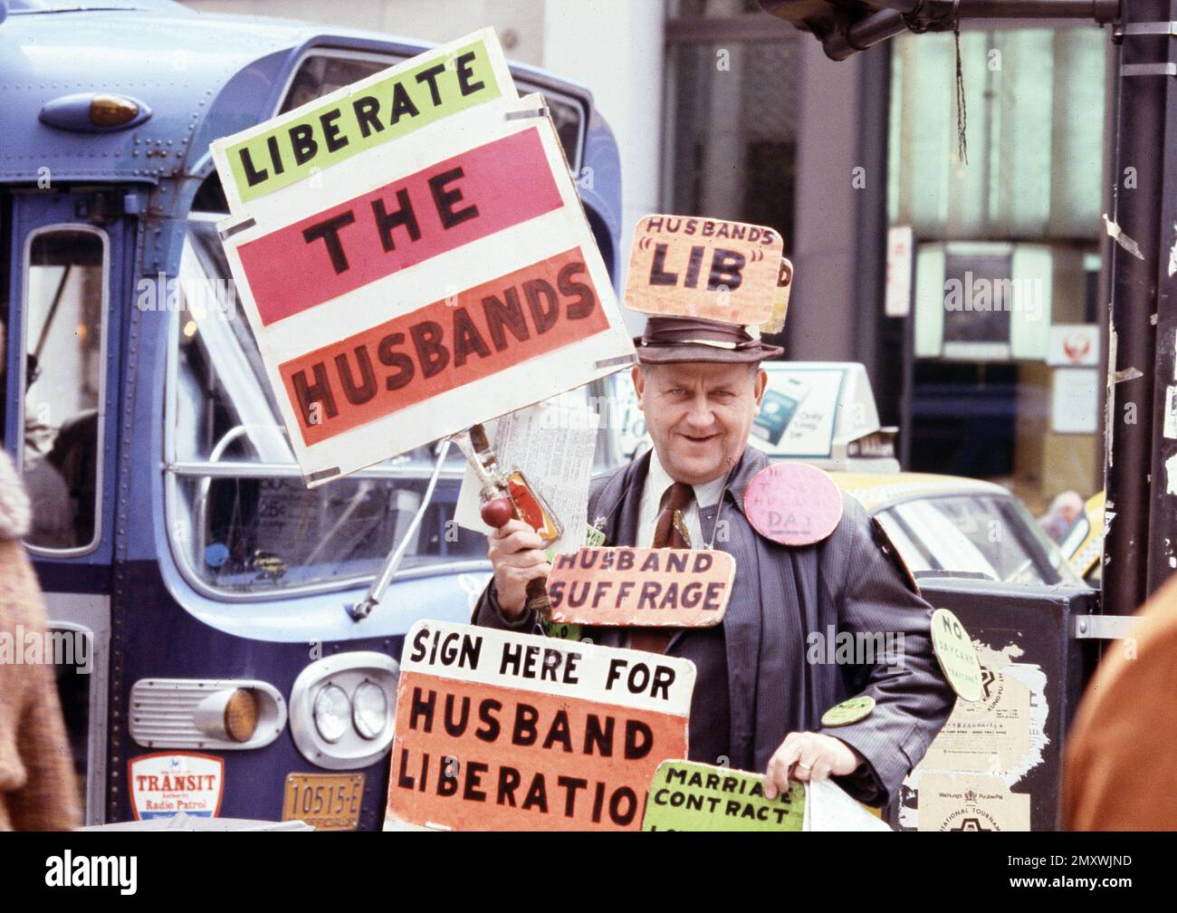 Harry Britton, a career protestor of "husband suffrage" stands with his ...