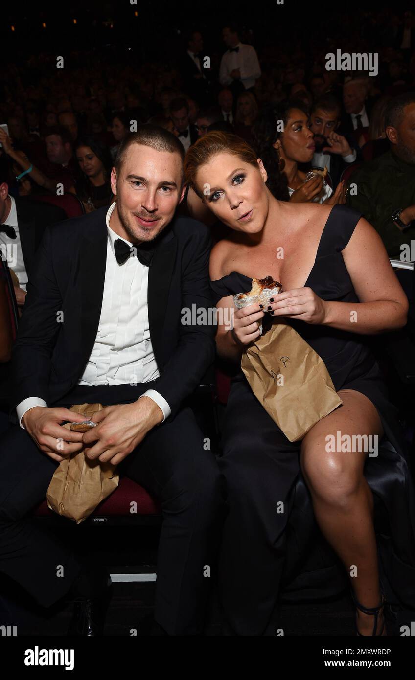 EXCLUSIVE - Ben Hanisch, left, and Amy Schumer pose in the audience at ...
