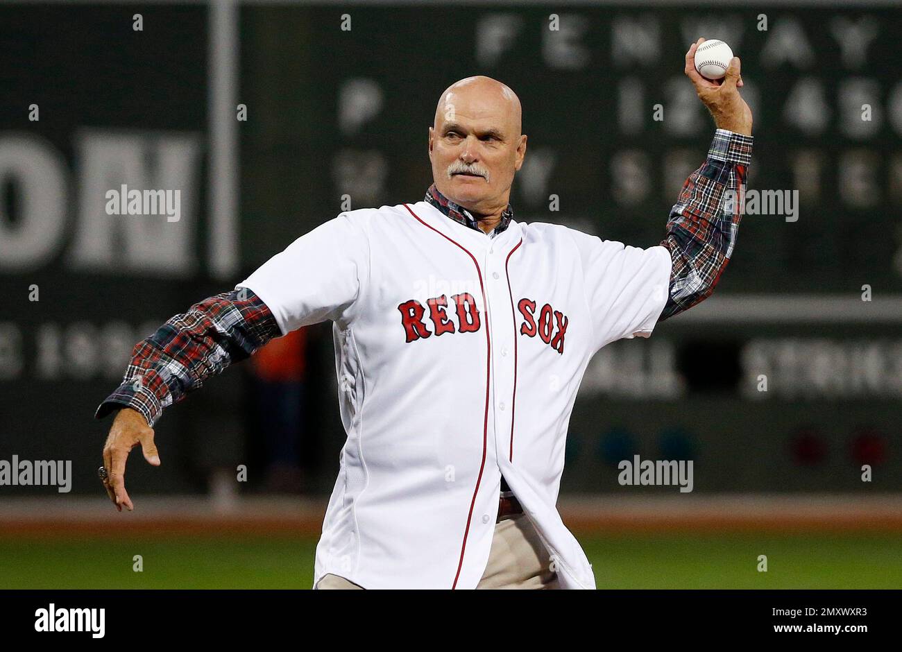 Dave Tomlin throws out the ceremonial first pitch before a baseball ...
