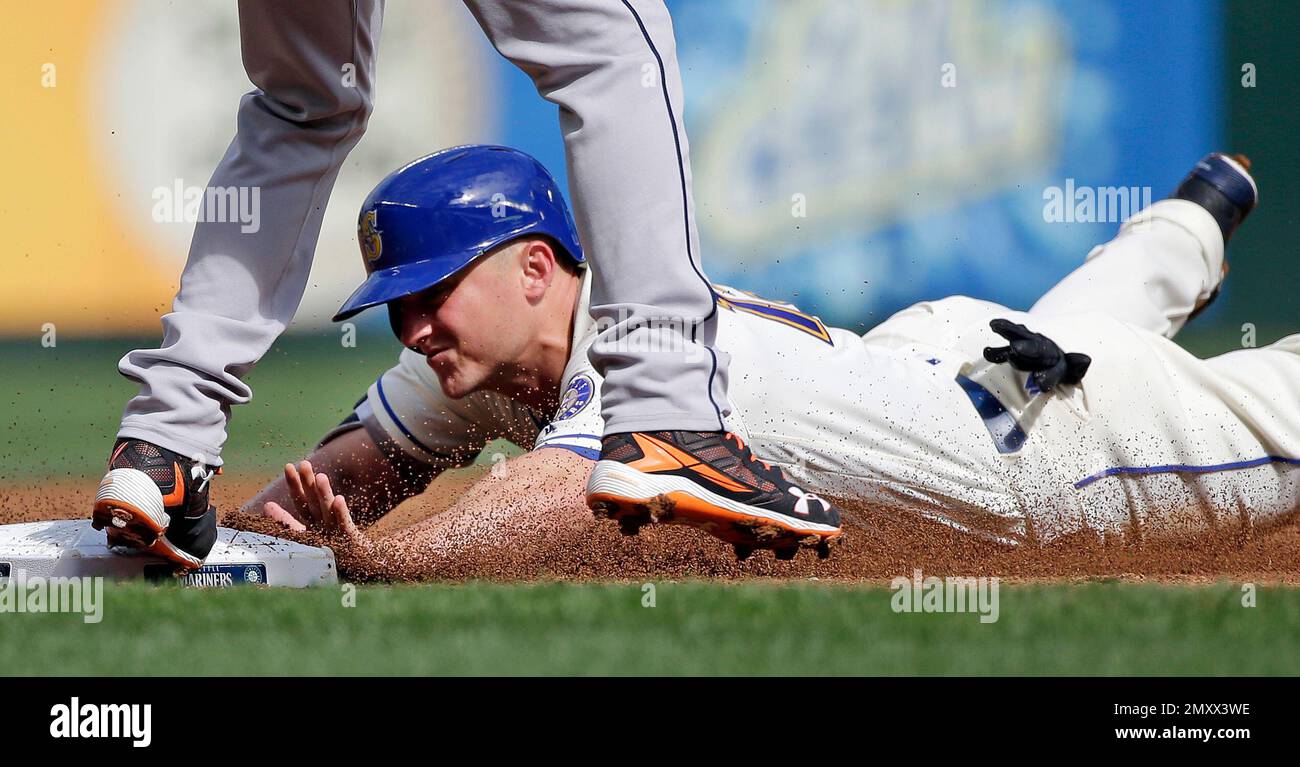 Seattle Mariners' Kyle Seager dives safely into third base after ...