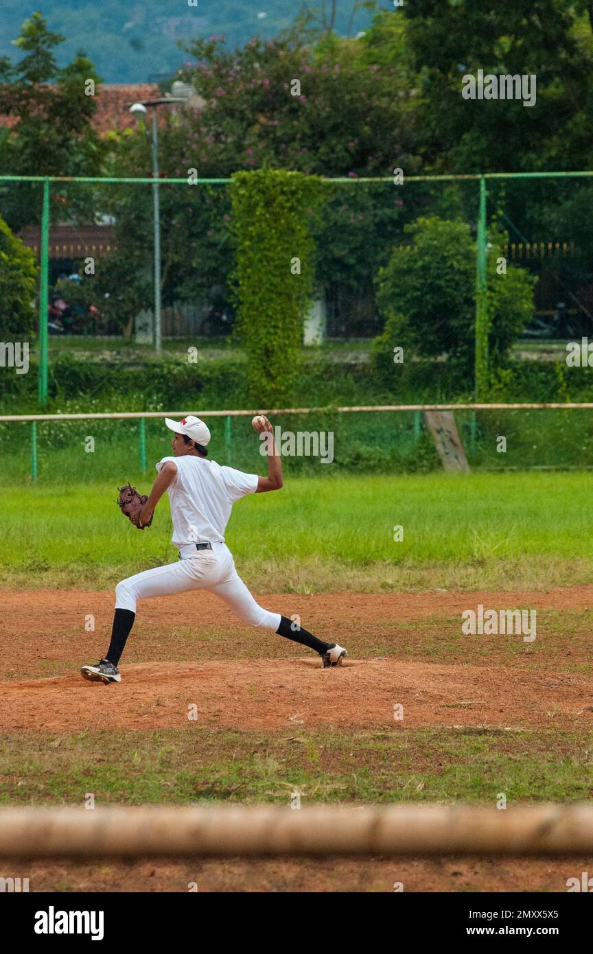 A baseball pitcher is throwing a ball in a stadium in Bandung ...