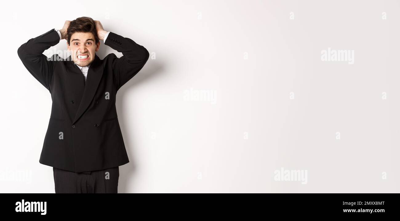 Image of frustrated and angry businessman in black suit, ripping hair ...