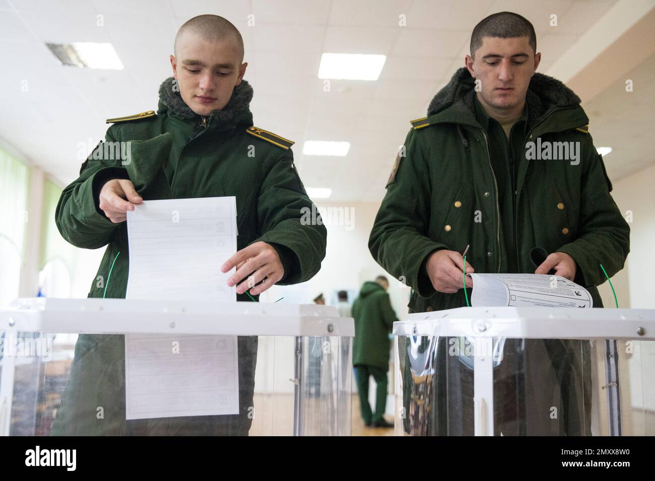 Russian military cadets cast their ballots at a polling station during ...