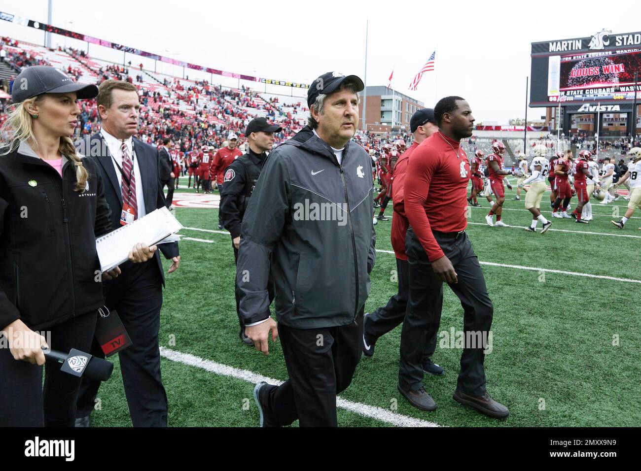 Washington State head coach Mike Leach walks on the field after an NCAA ...