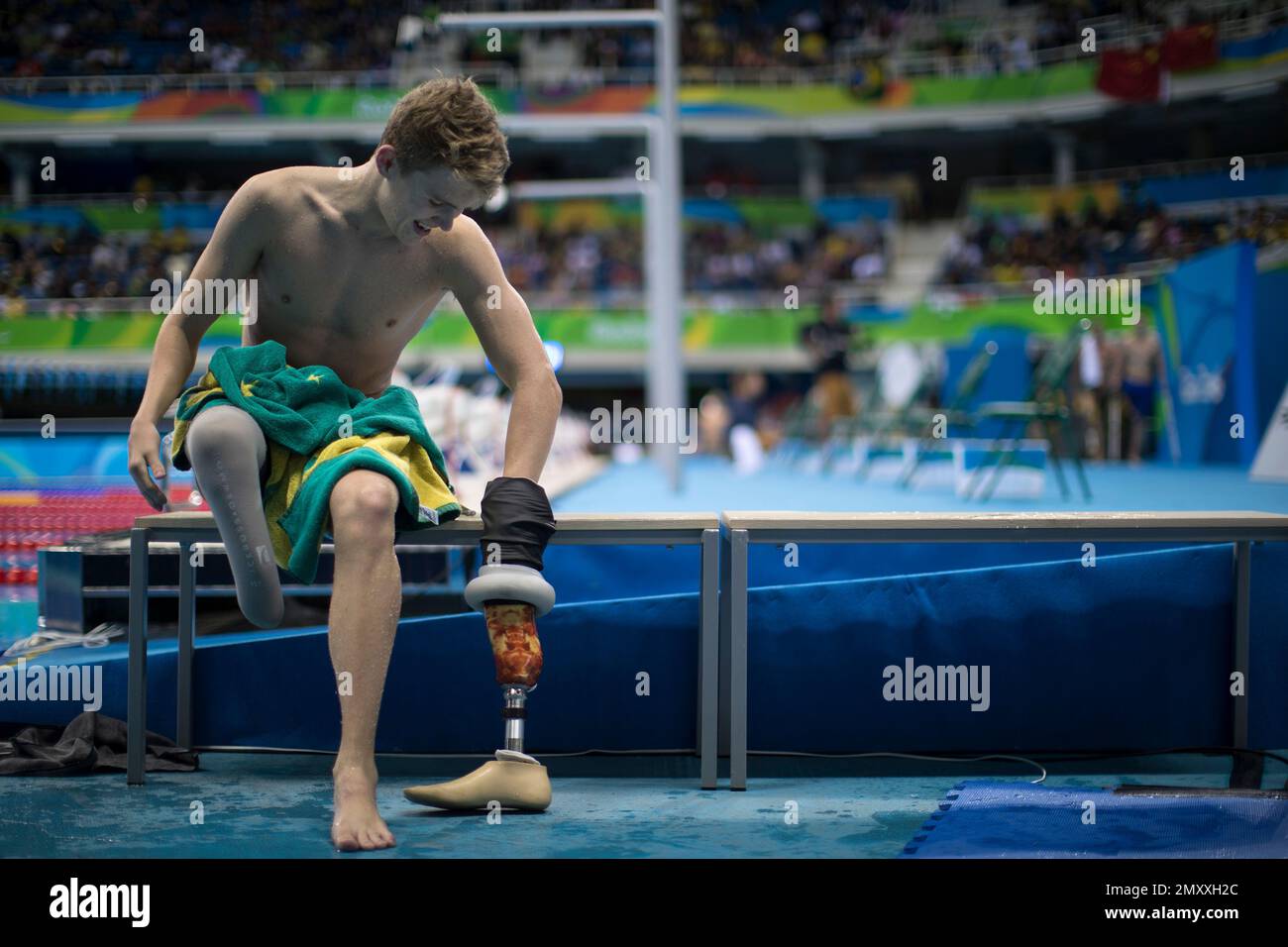Australia's Timothy Hodge puts his prosthetic leg on after competing in ...