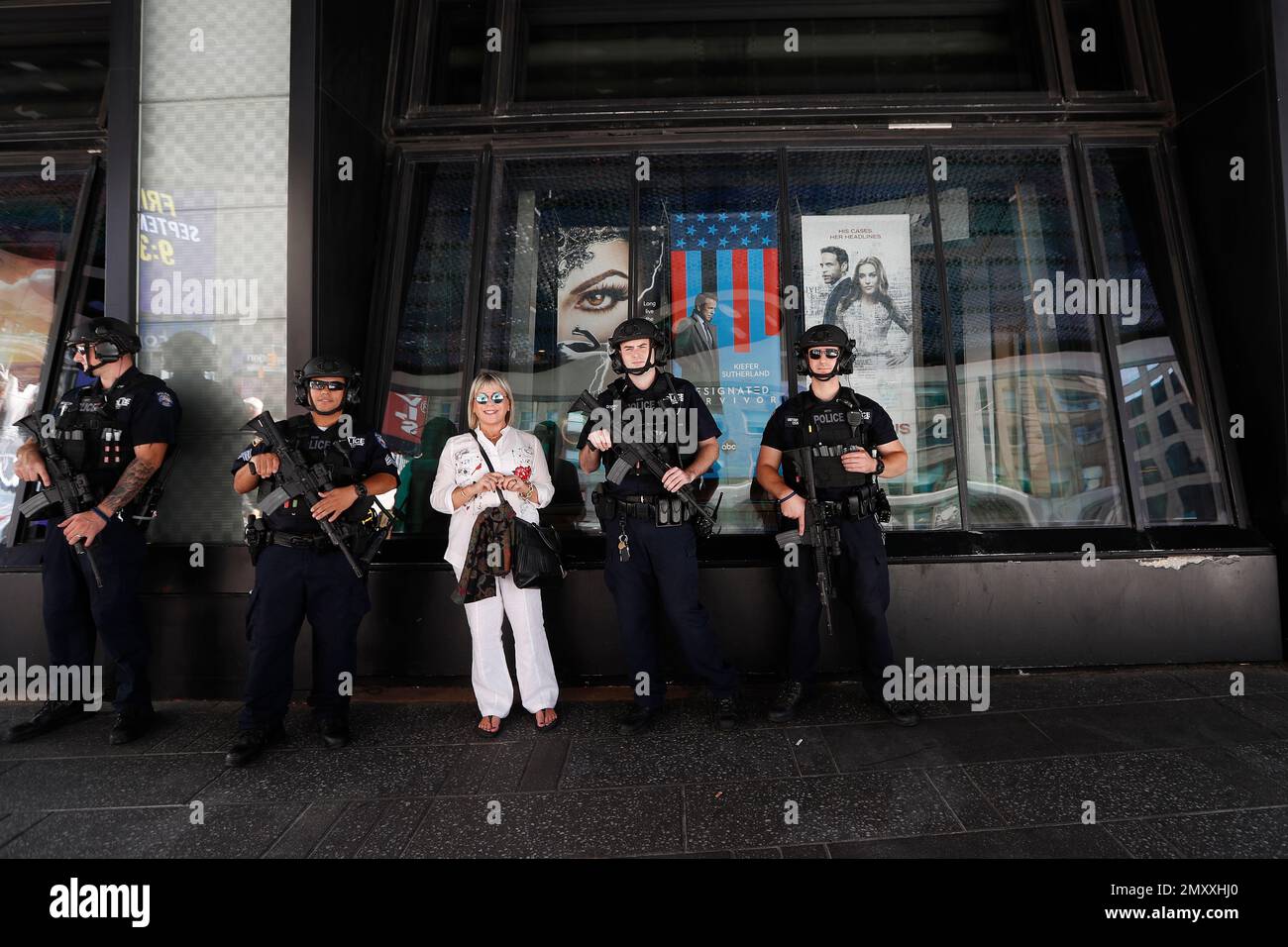 A visitor to New York's Times Square poses for a photo with a group of ...