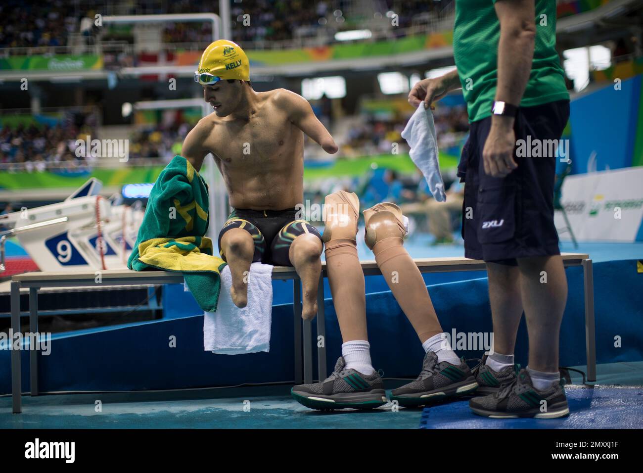 Australia's Ahmed Kelly sits before putting on his prosthetic legs ...