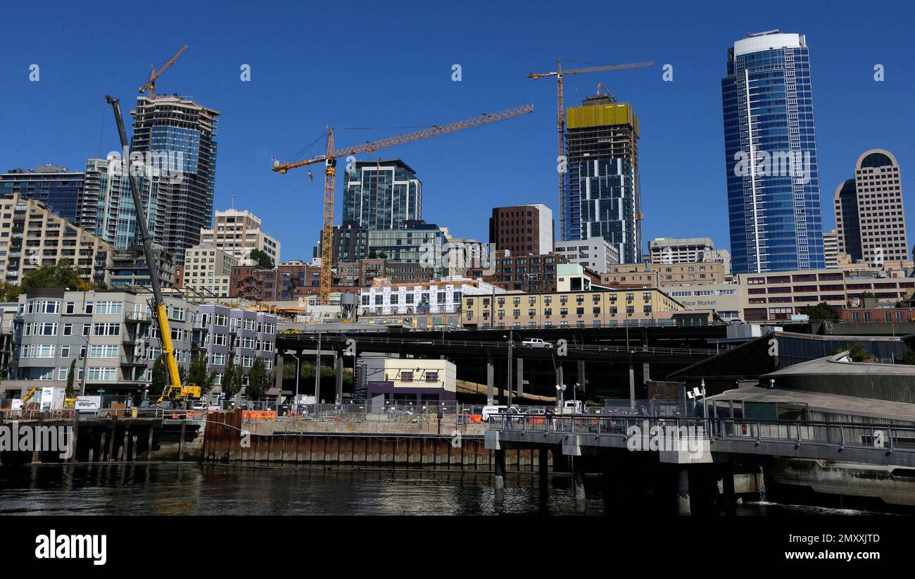 Cranes are shown near buildings under construction in downtown Seattle ...