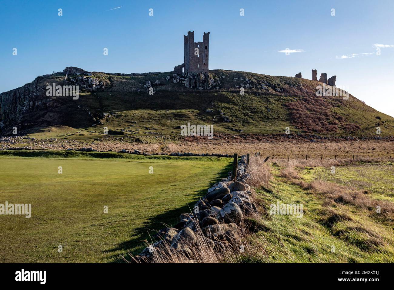 The 14th-century fortiress of Dunstanburgh Castle on the coast of ...