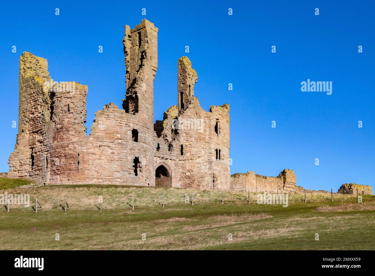 The 14th-century fortiress of Dunstanburgh Castle on the coast of ...