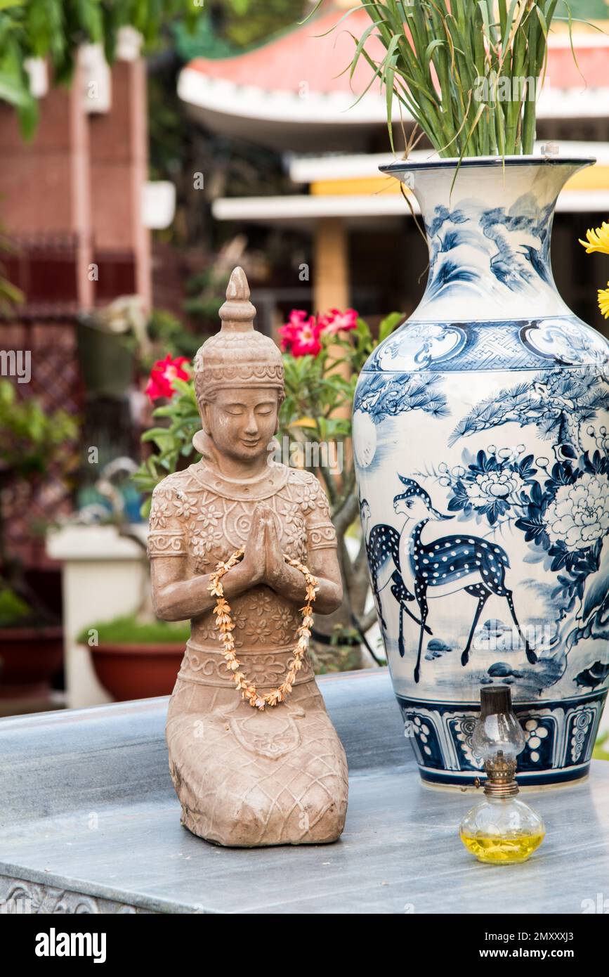 Buddha statue and blue flower vase in a Buddhist temple Stock Photo - Alamy