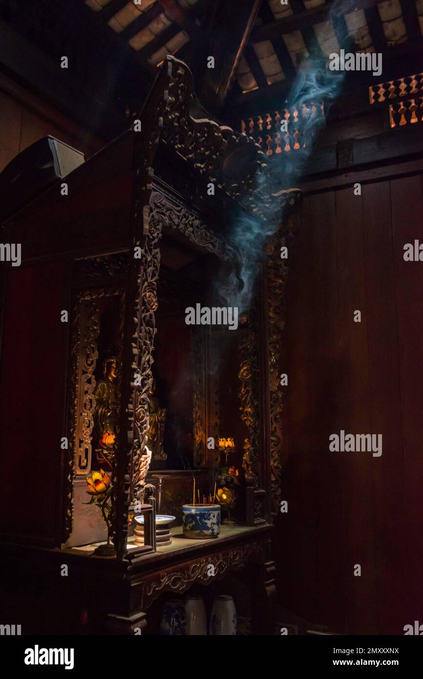 Incense smoke in a temple with ray of light on an altar in Buddhist ...