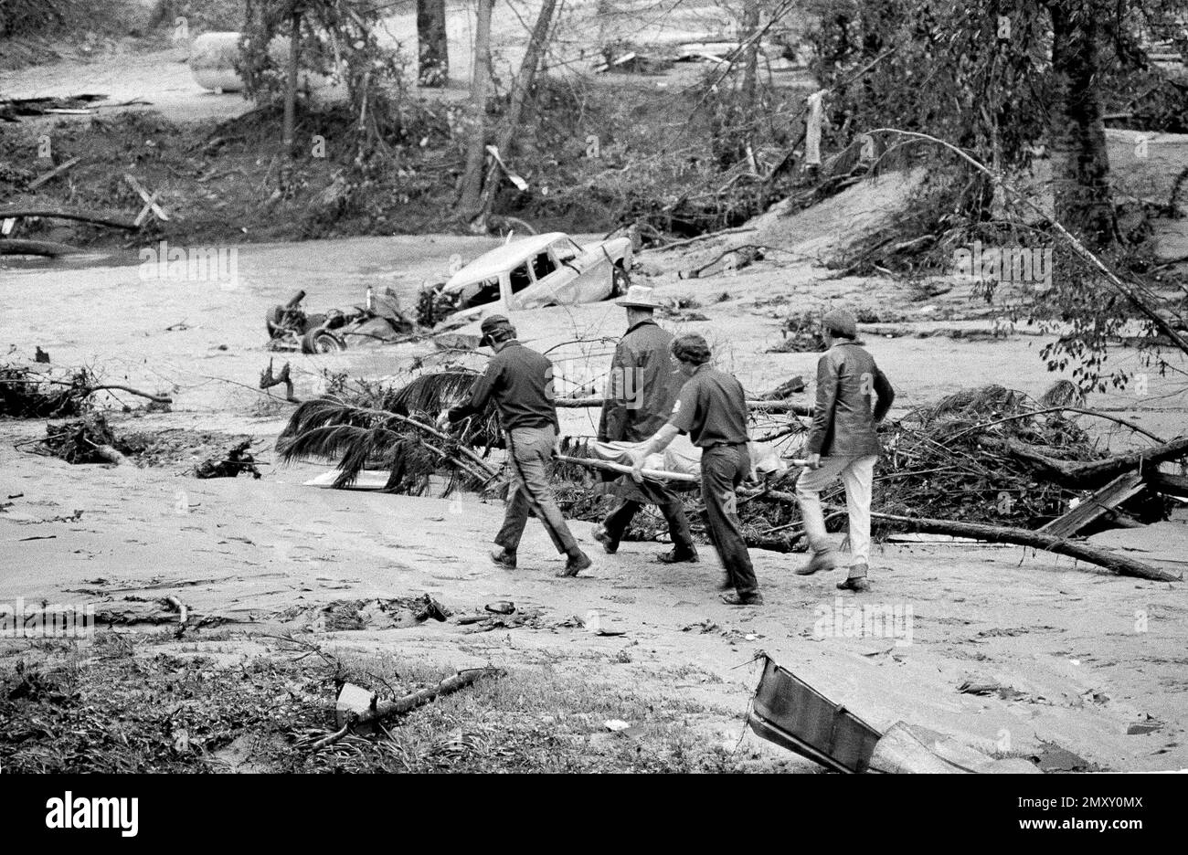 Rescue workers remove a body from the flooding waters near the Toccoa ...