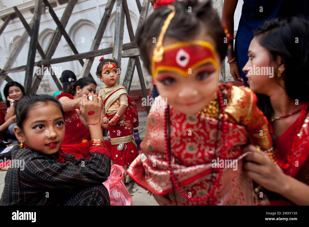 Young Nepalese girls wearing traditional costumes wait for the Kumari ...